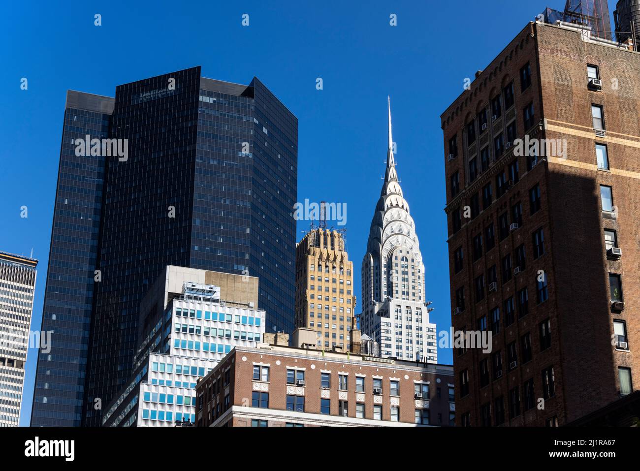 Chrysler Building stands among Midtown Manhattan skyscraper NYC Stock ...