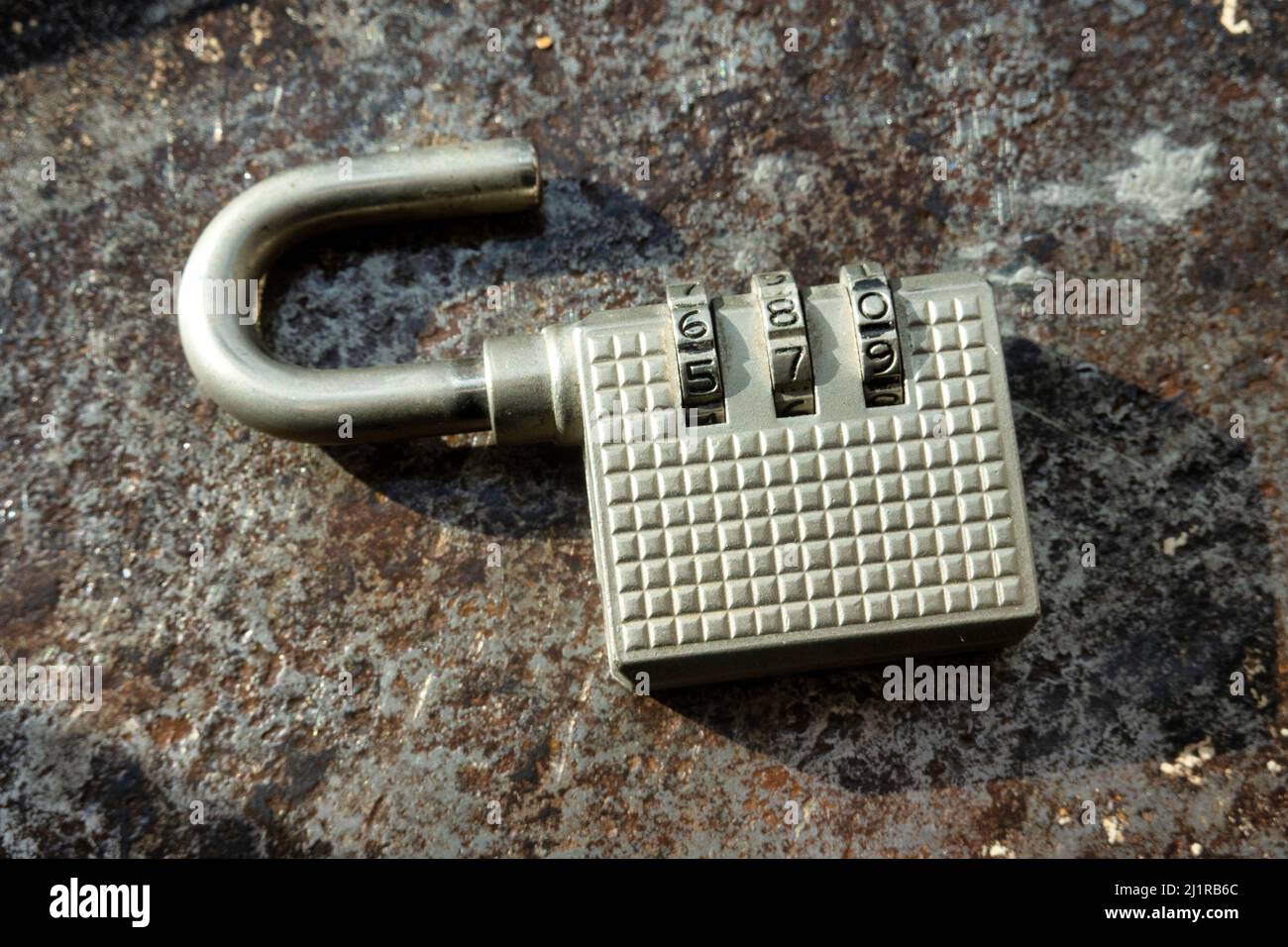 Open combination padlock on a distressed surface, USA 2022 Stock Photo ...