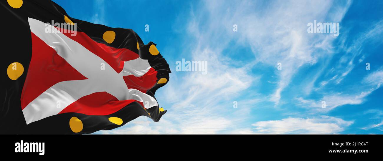 flag of Hampton Poyle village , UK at cloudy sky background on sunset ...