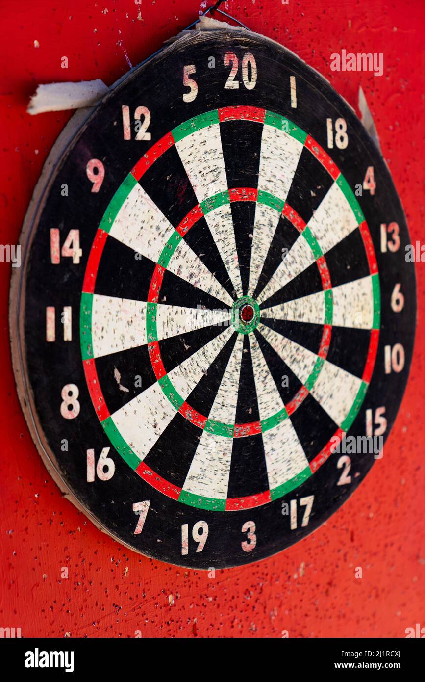 The target of the game of darts on a red background. Concept of success ...