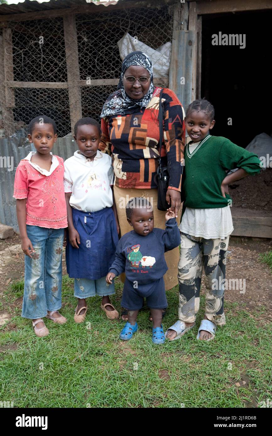Aid worker with children, Majengo slum, Meru Stock Photo - Alamy