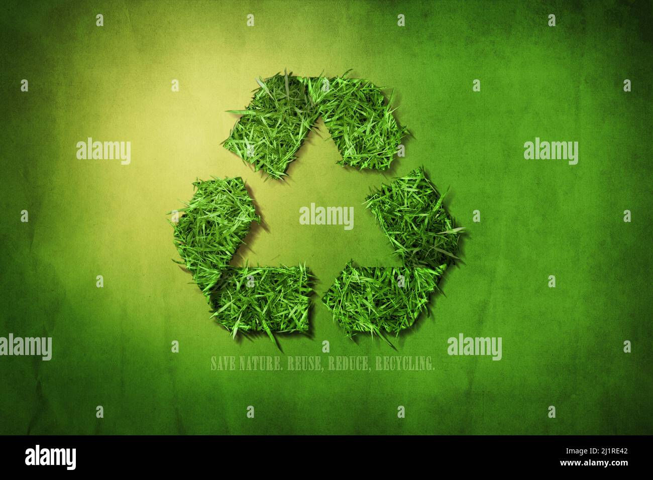 Recycling sign created from grass. Green grunge background. Reuse ...