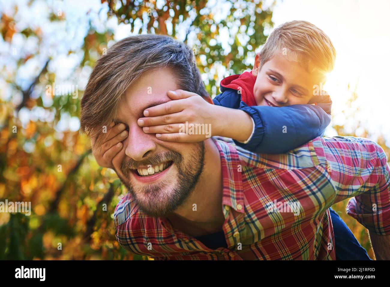 Can you see. Cropped shot of an adorable young boy closing his fathers ...