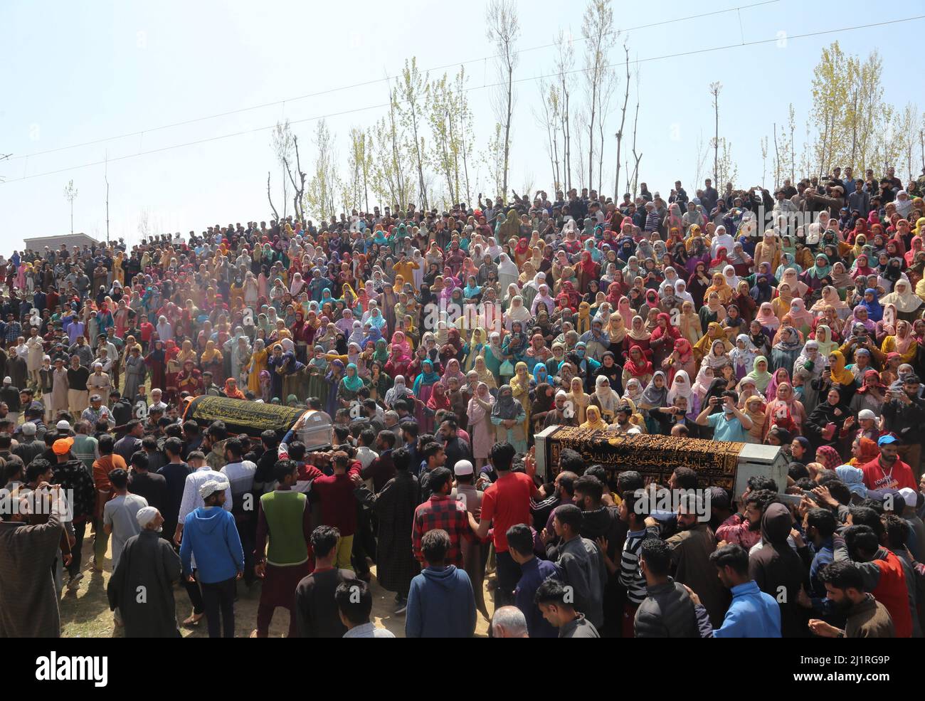 Kashmiri villagers carry the coffins of slain Indian policeman Ishfaq ...