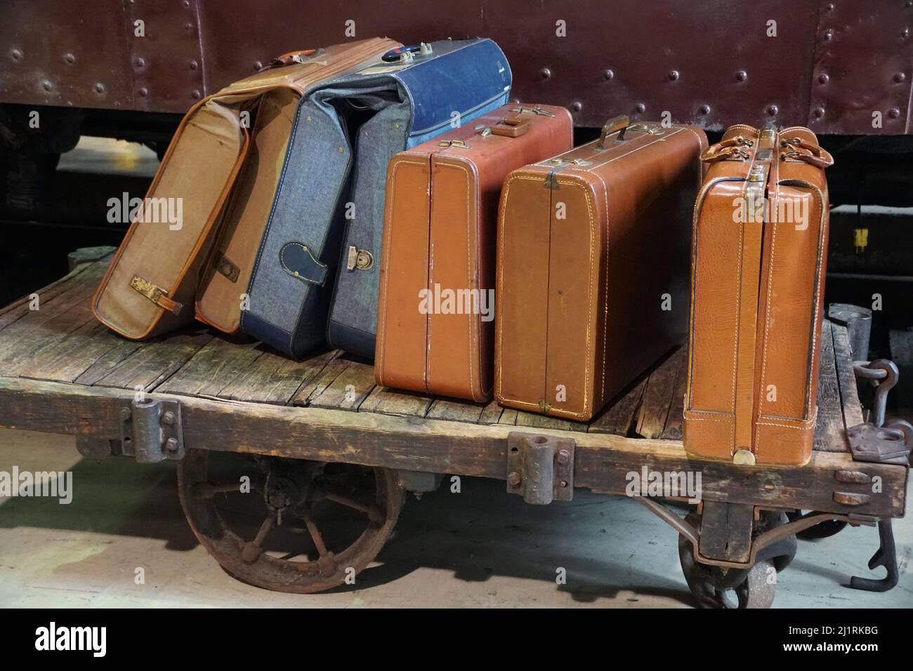 A stack of old luggage on a baggage cart Stock Photo - Alamy