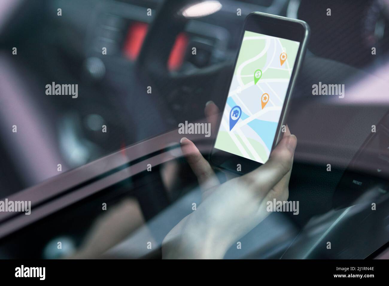 Exploring all possible routes. Shot of a woman in a car using a phone ... Exploring all possible routes. Shot of a woman in a car using a phone ...