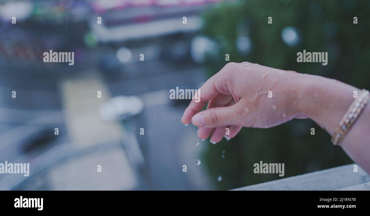 Rainy weather, rain drops falling on womans hand Stock Photo - Alamy