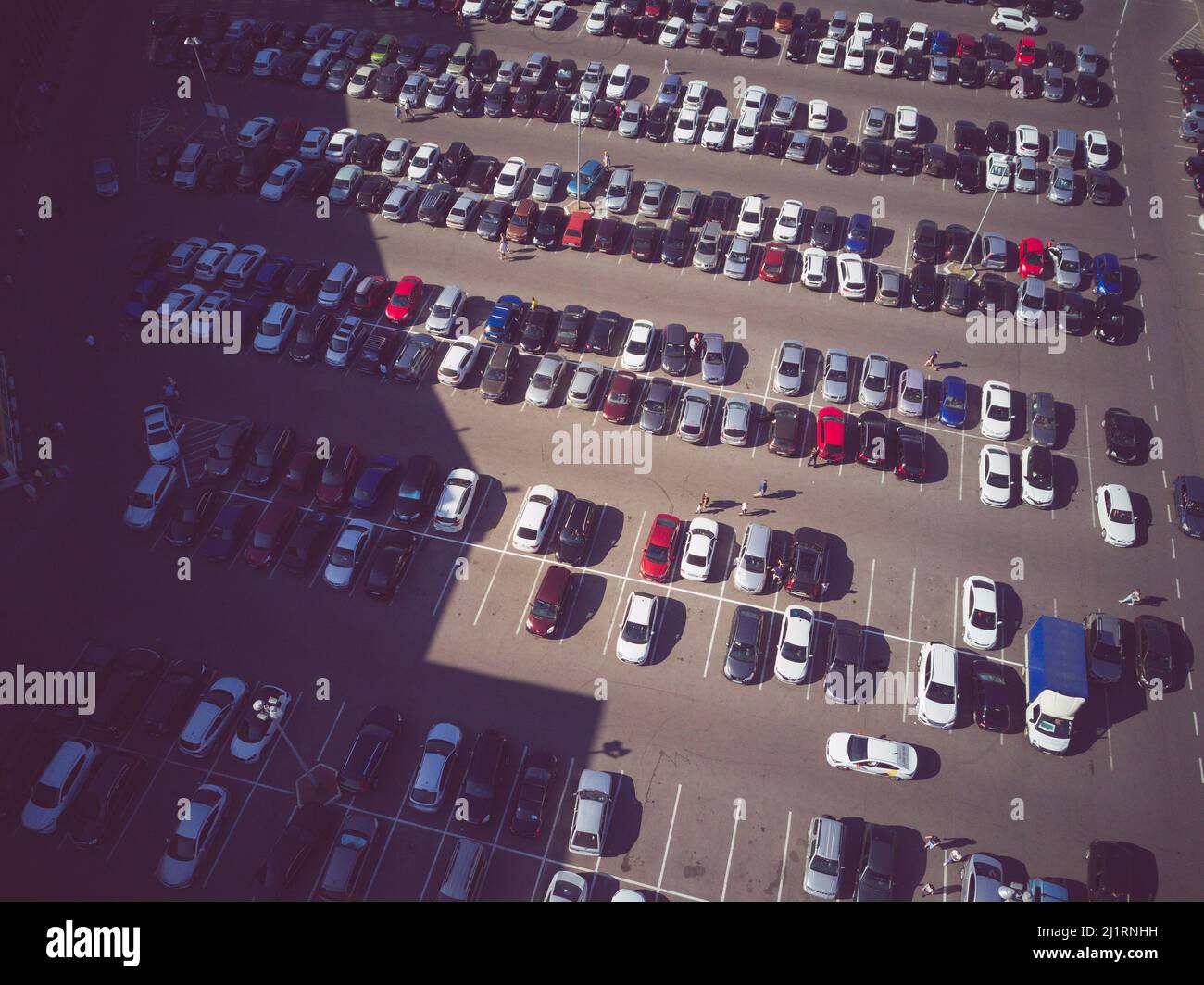 A view from above to the process of car parking. Heavy traffic in the ...
