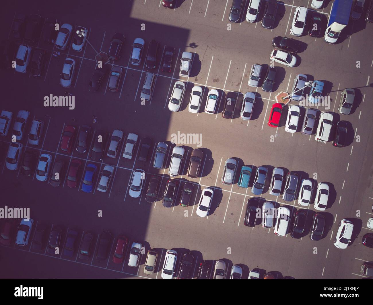 A view from above to the process of car parking. Heavy traffic in the ...