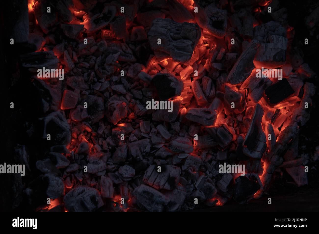 Actively smoldering embers of fire. Background of burning hot coals ...