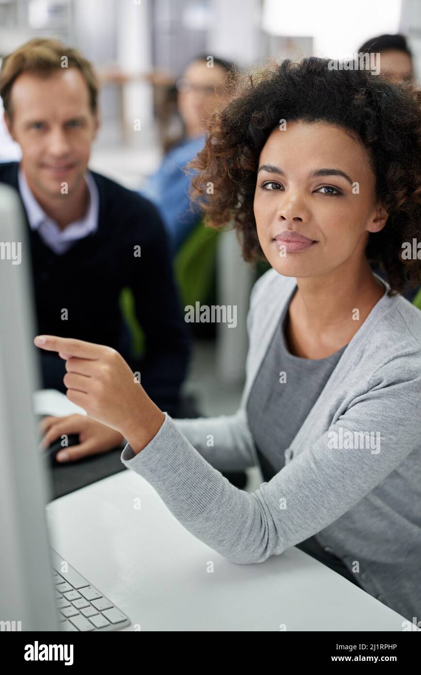 The news is out. Serious businesswoman pointing at her computer screen ...