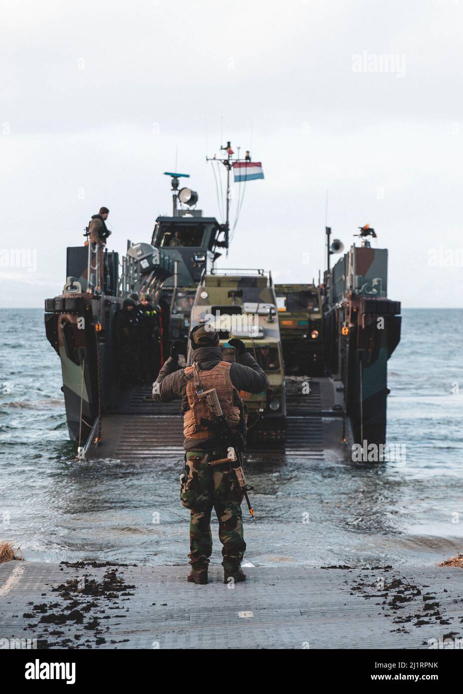 A Korps Marinier with the Royal Netherlands Marine Corps guides a U.S ...