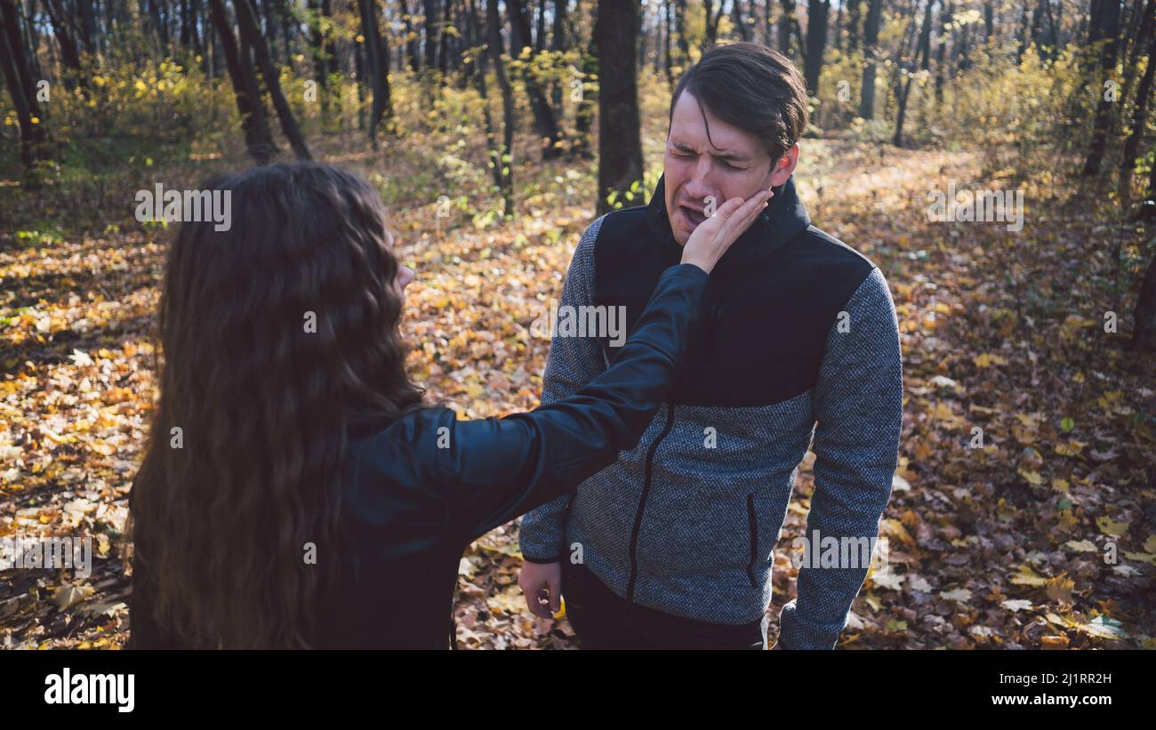 Unhappy scared man getting slapped standing into the park Stock Photo ...