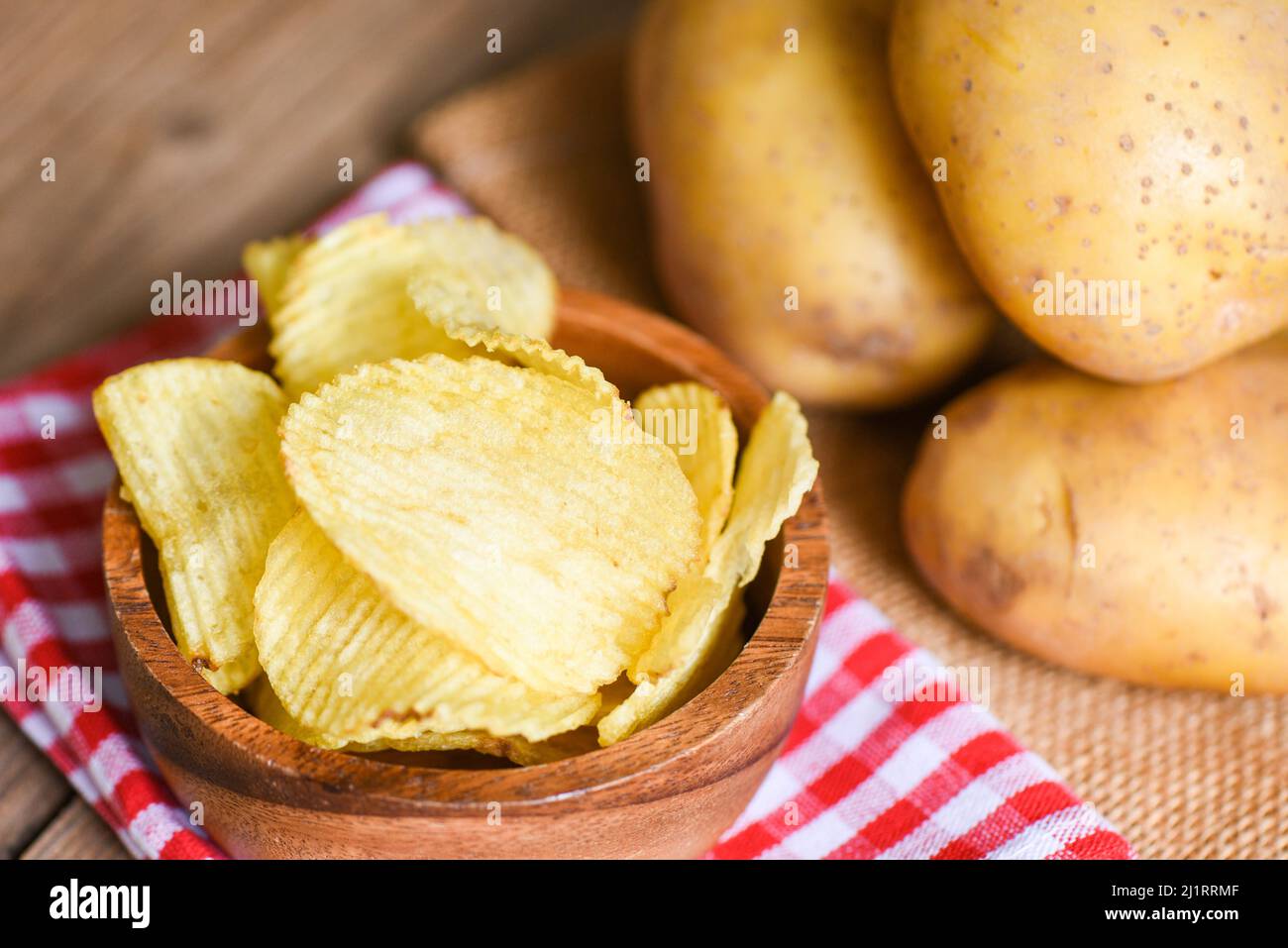 Potato chips snack on bowl, Crispy potato chips on the kitchen table ...