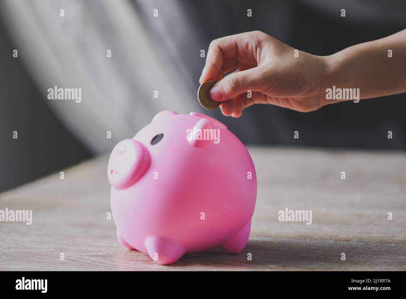 Save money concept, child hand putting money coin into piggy bank for ...