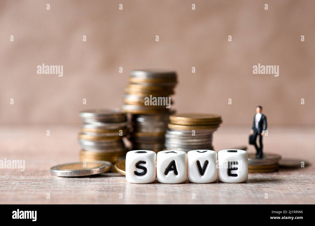 Save money concept, businessmen stand on money coin and save block word ...