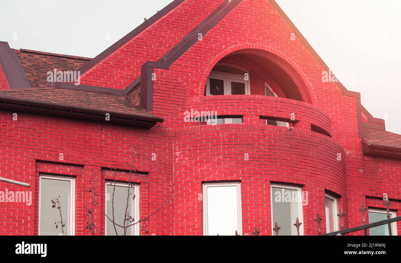 Close-up of a part of the facade of a red brick cottage house with ...