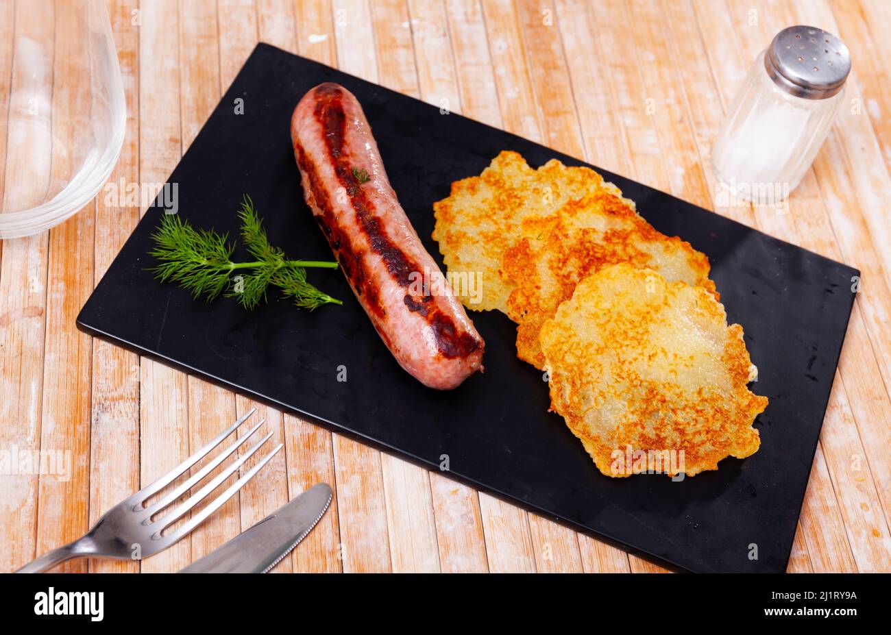 National dish of Belarusian cuisine is draniki with fried sausages ...