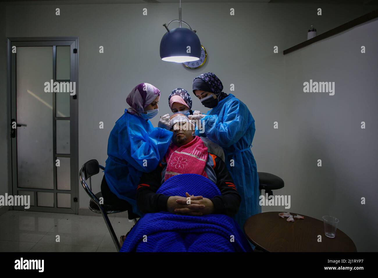 Gaza City. 19th Mar, 2022. A man receives a hair implant surgery at a ...