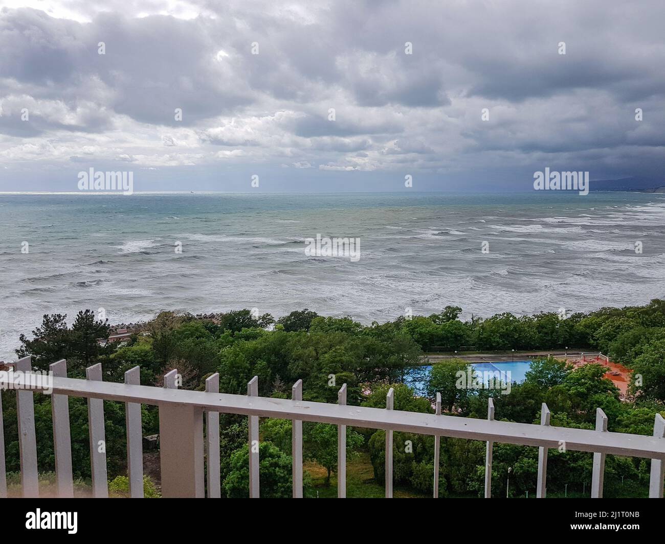 Sea view with waves and sky from the hotel terrace, morning, cloudy ...