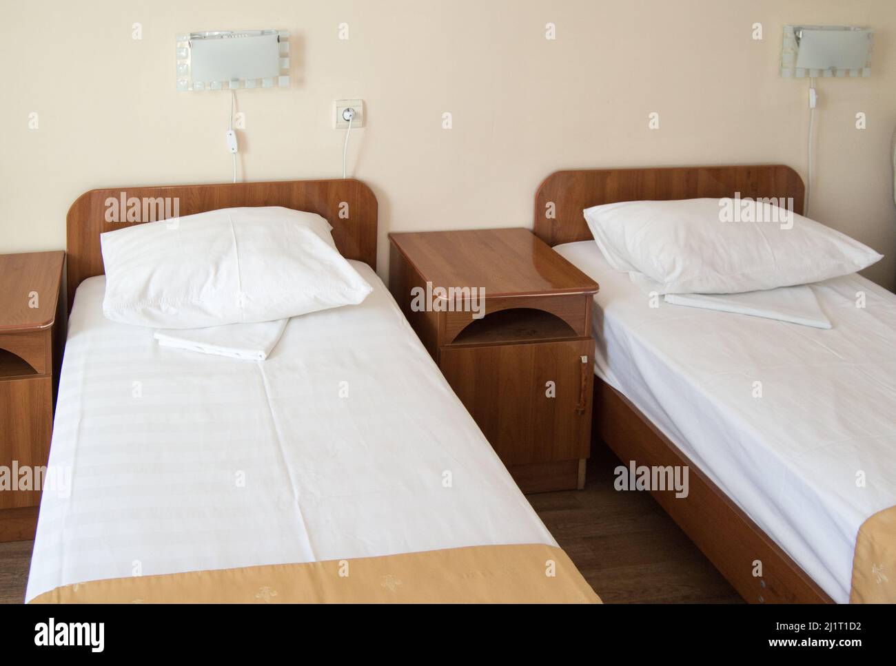 Hotel room with two empty SINGLE beds and bedside tables, the concept ...