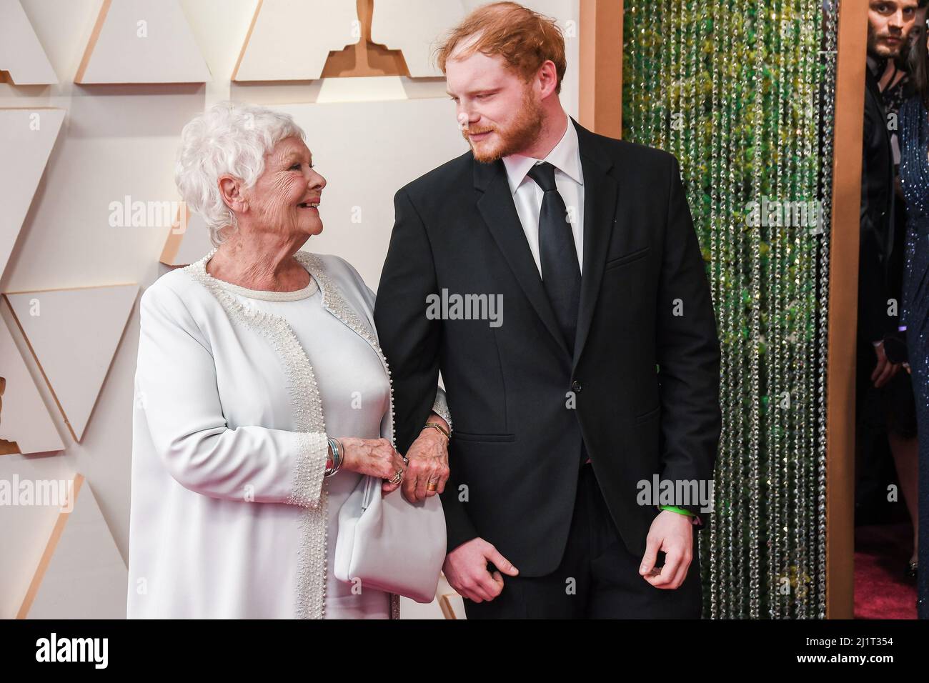 Judi Dench and Sam Williams walking on the red carpet at the 94th ...