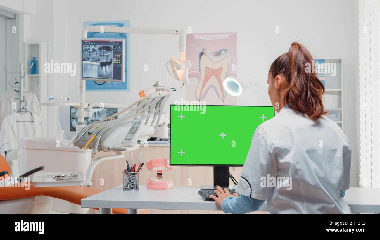 Dentist looking monitor horizontal green hi-res stock photography and ...