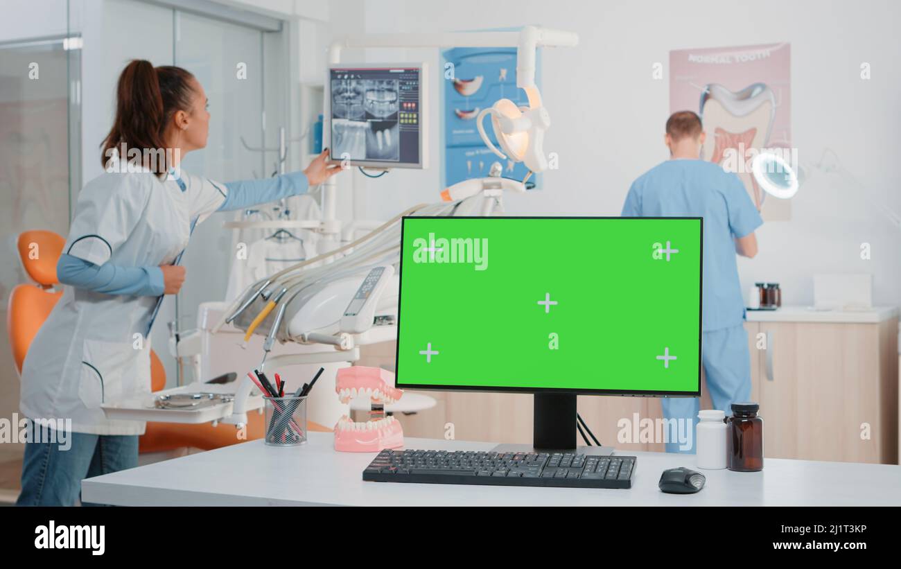 Monitor with green screen on desk in dentist office for dental checkup ...