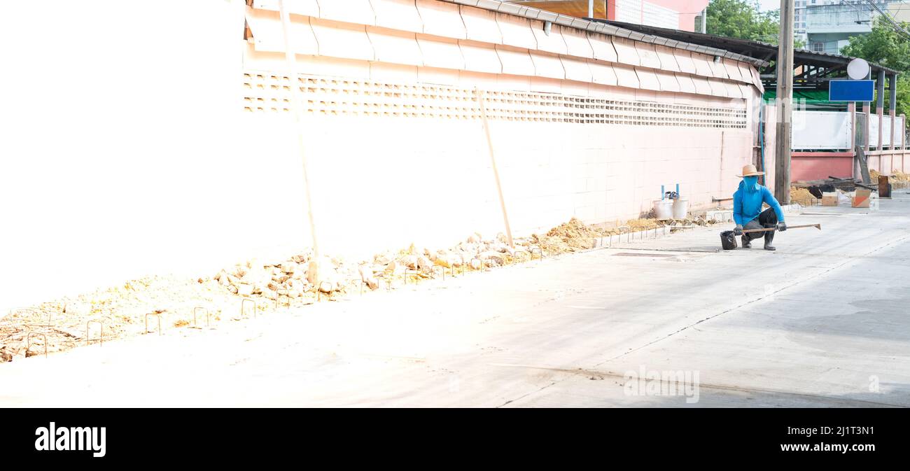 The worker man working for the building the road with the cement at the ...
