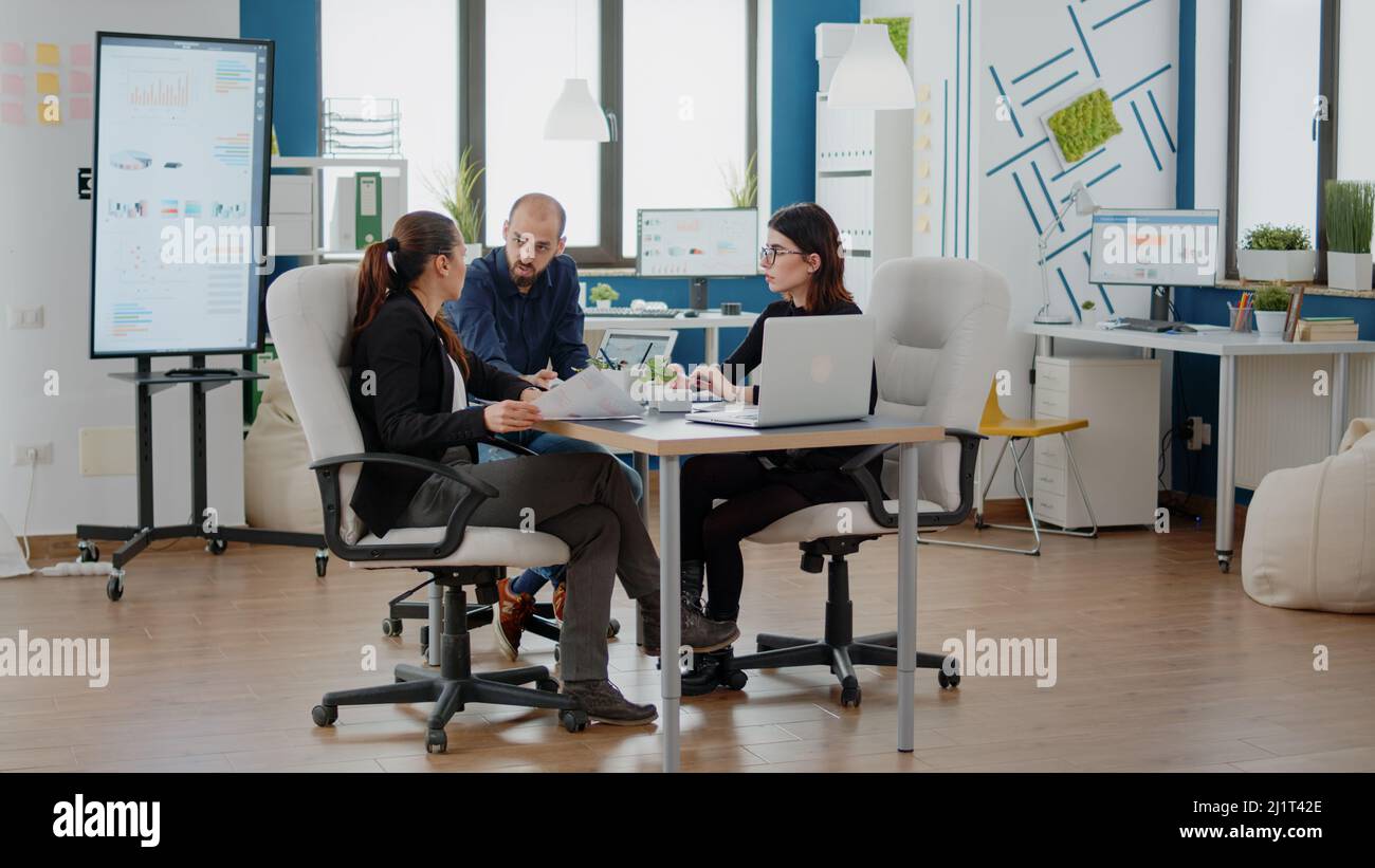 Manager and colleagues at business meeting for strategy briefing in ...