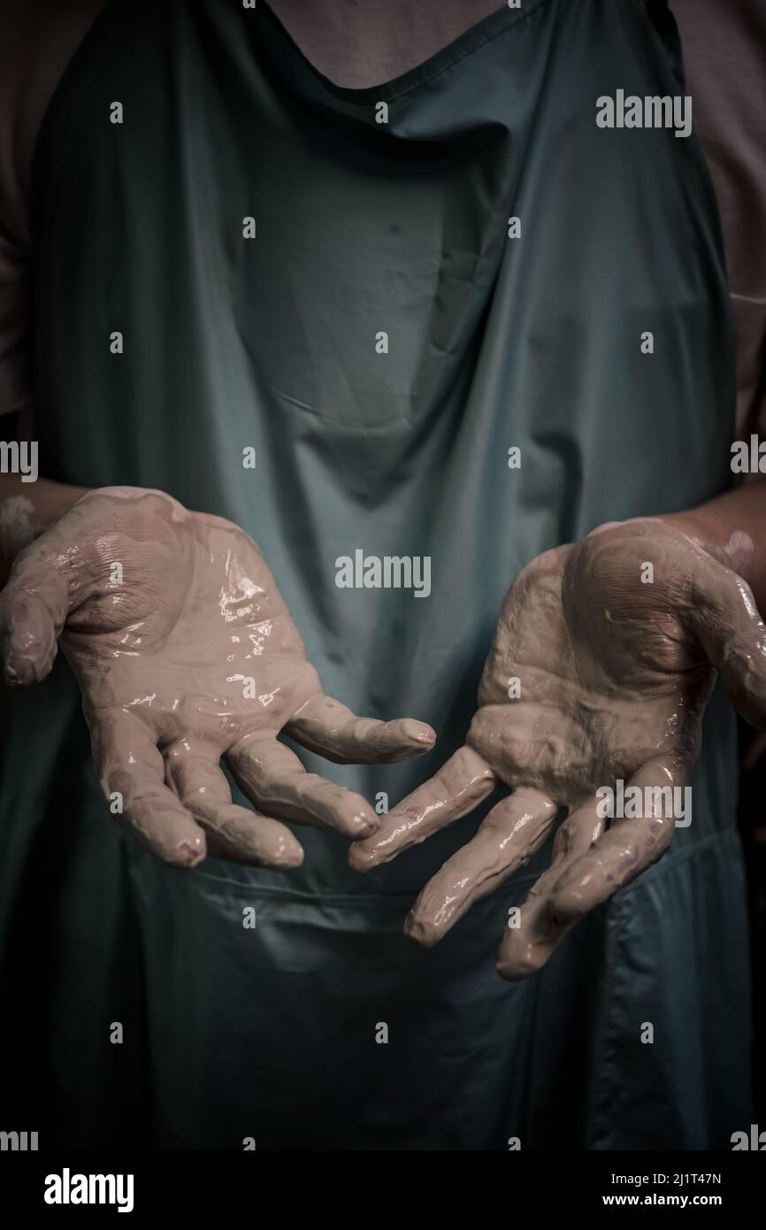 Hands in clay after working at the potter's wheel, close-up Stock Photo ...