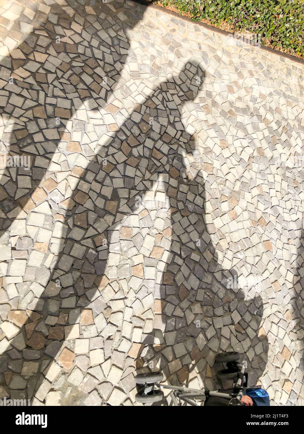Shadow of a parent pushing a baby umbrella stroller Stock Photo - Alamy