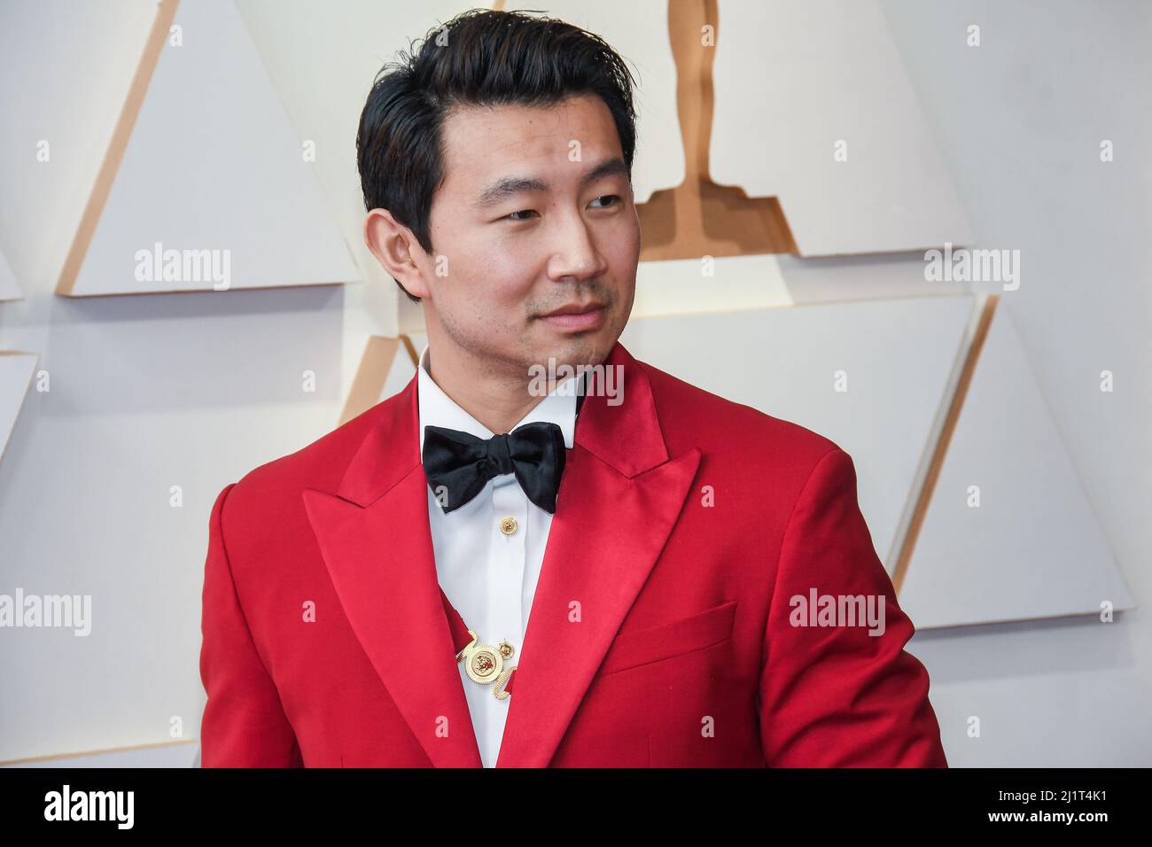 Simu Liu walking on the red carpet at the 94th Academy Awards held at ...