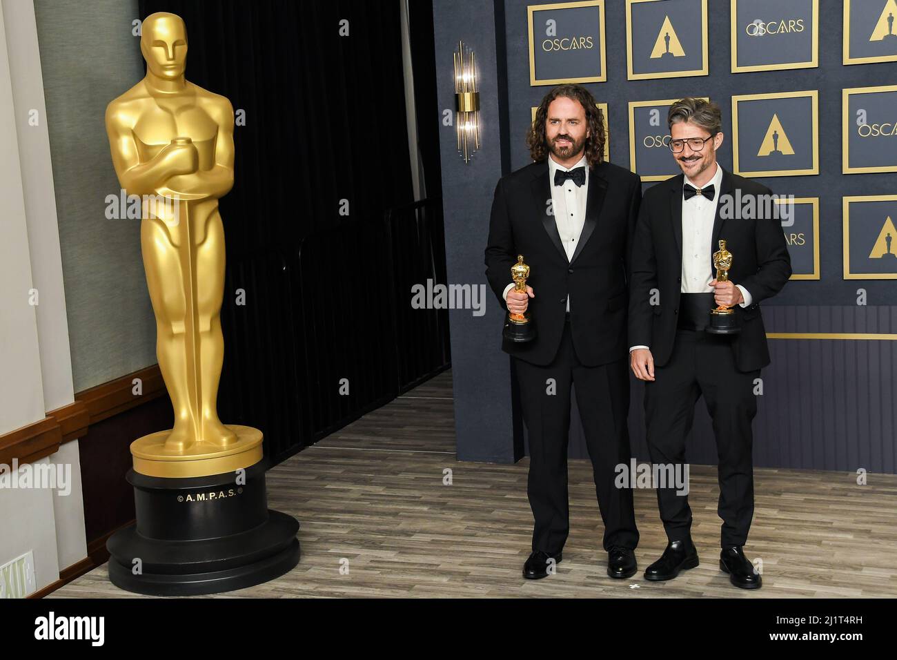 Leo Sanchez and Alberto Mielgo posing on the stage in the press room ...