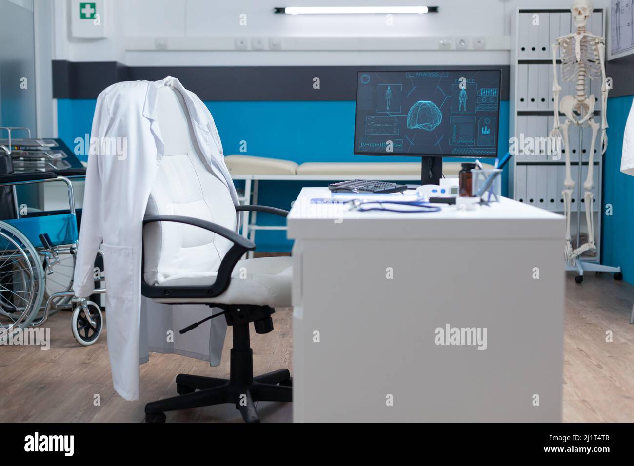 Computer with patient bone structure on screen standing on table in ...