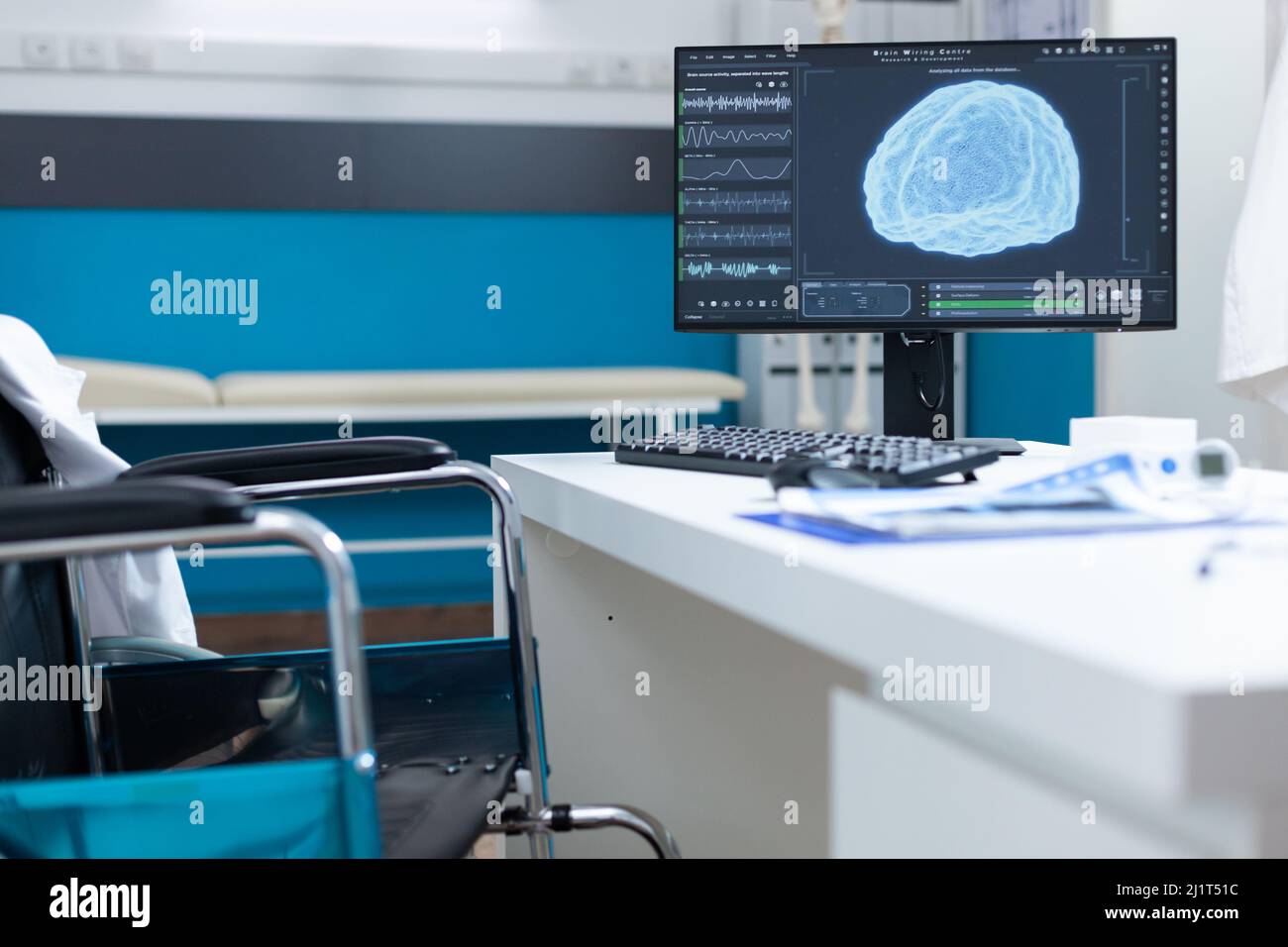 Computer standing on table having brain ct-scan on screen during ...