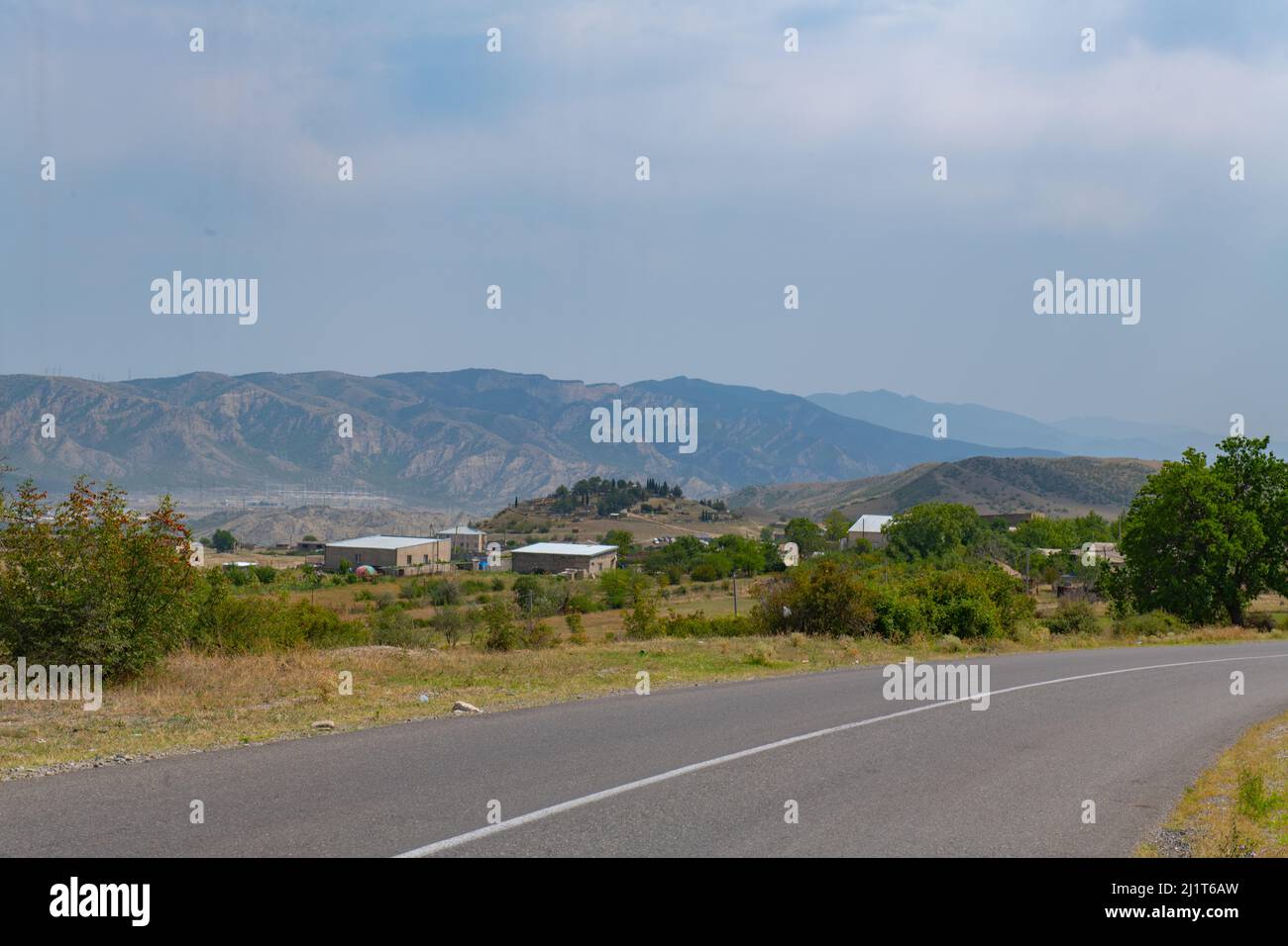 a wide asphalt road goes through beautiful places Stock Photo - Alamy