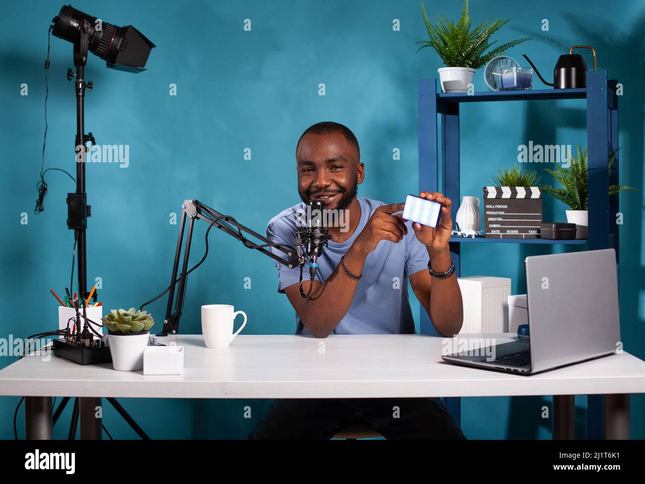 Vlogger presenting rgb small video light review pointing at product ...