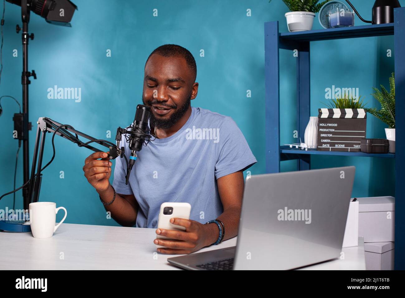 Influencer talking in boom arm microphone recording video with ...