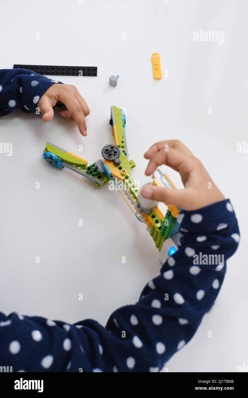 Coding Class, school girl constructing robot arm mechanism. multiethnic ...