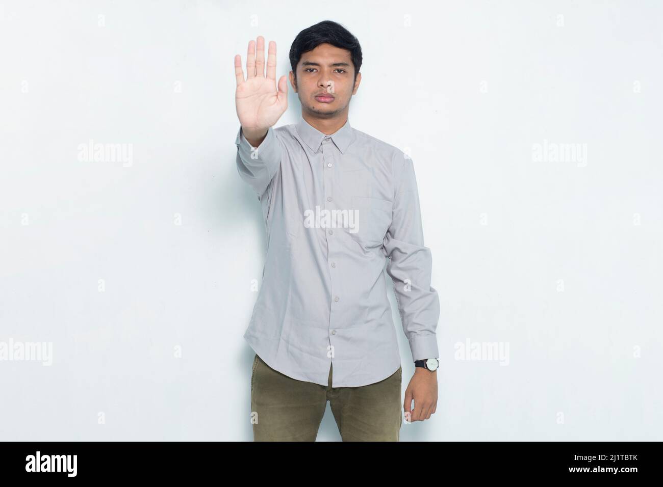Handsome young asian business man with open hand doing stop sign with ...