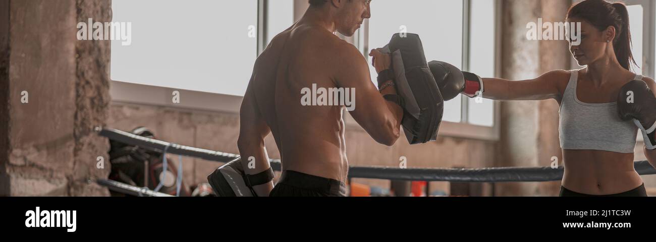Female boxer sparring with man coach in boxing club Stock Photo - Alamy