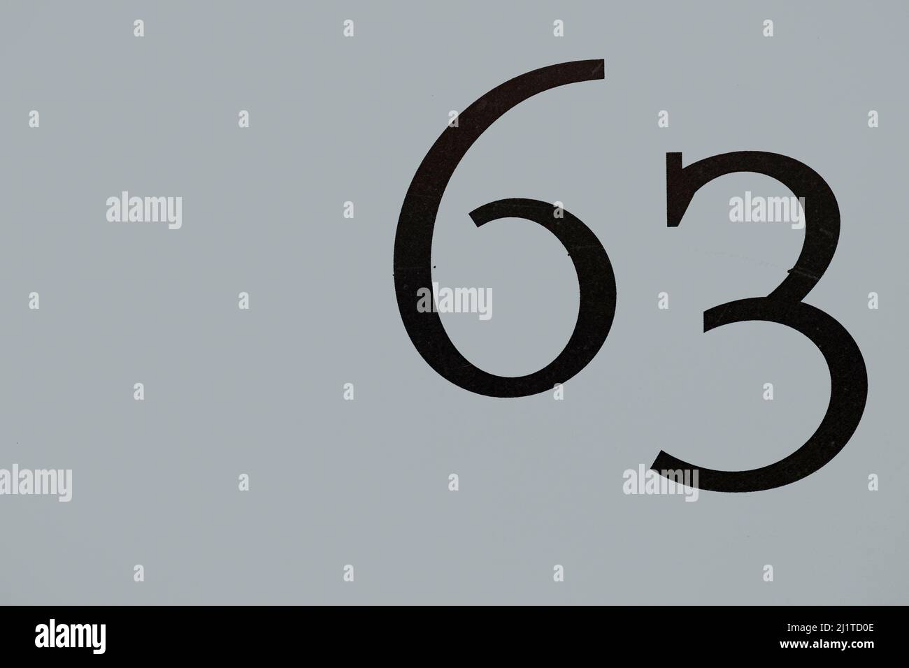 house number 63 painted at the grey wall Stock Photo - Alamy