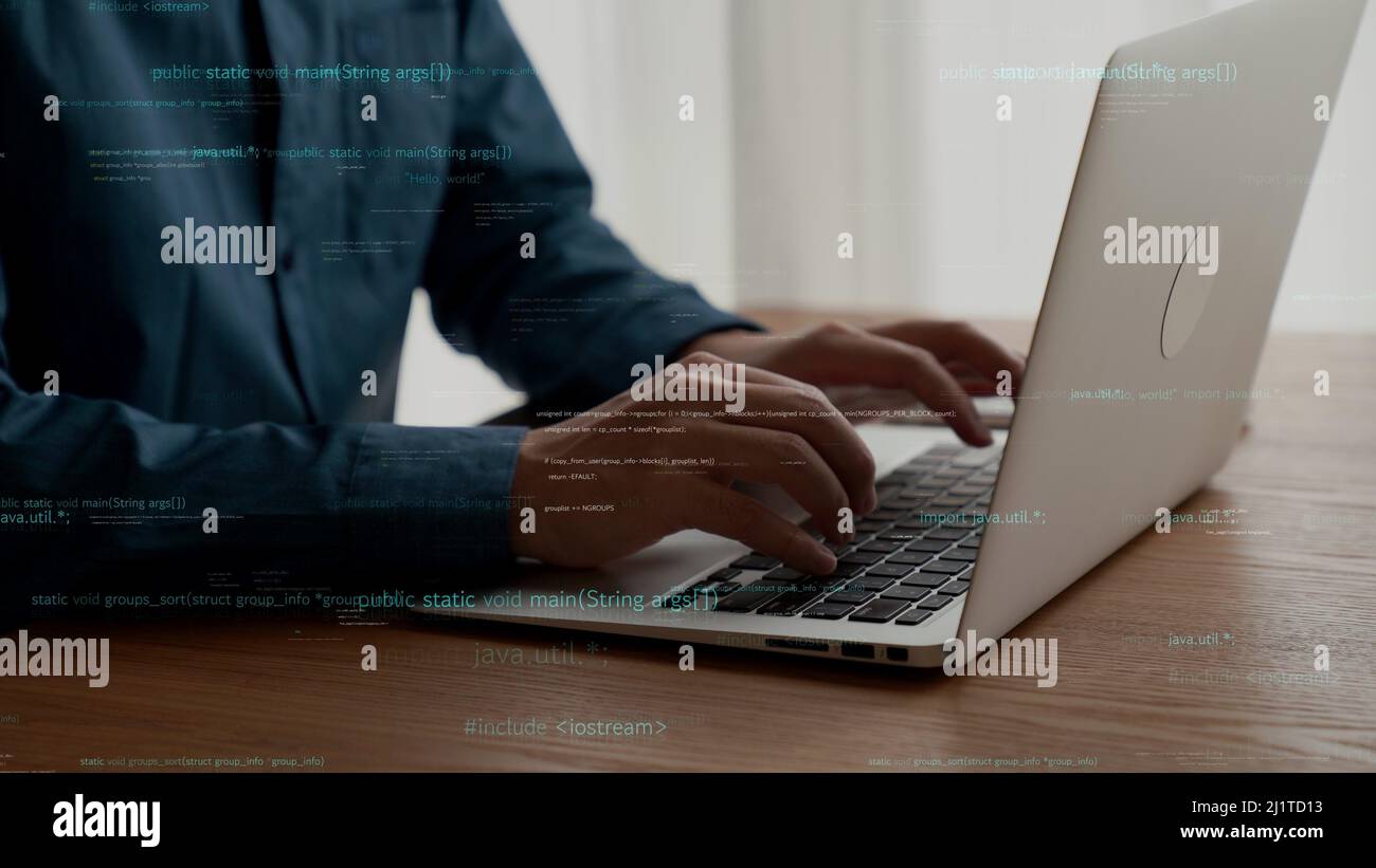 Computer Programmer Uses Capable Laptop Computer To Develop Programming Code Of New Software