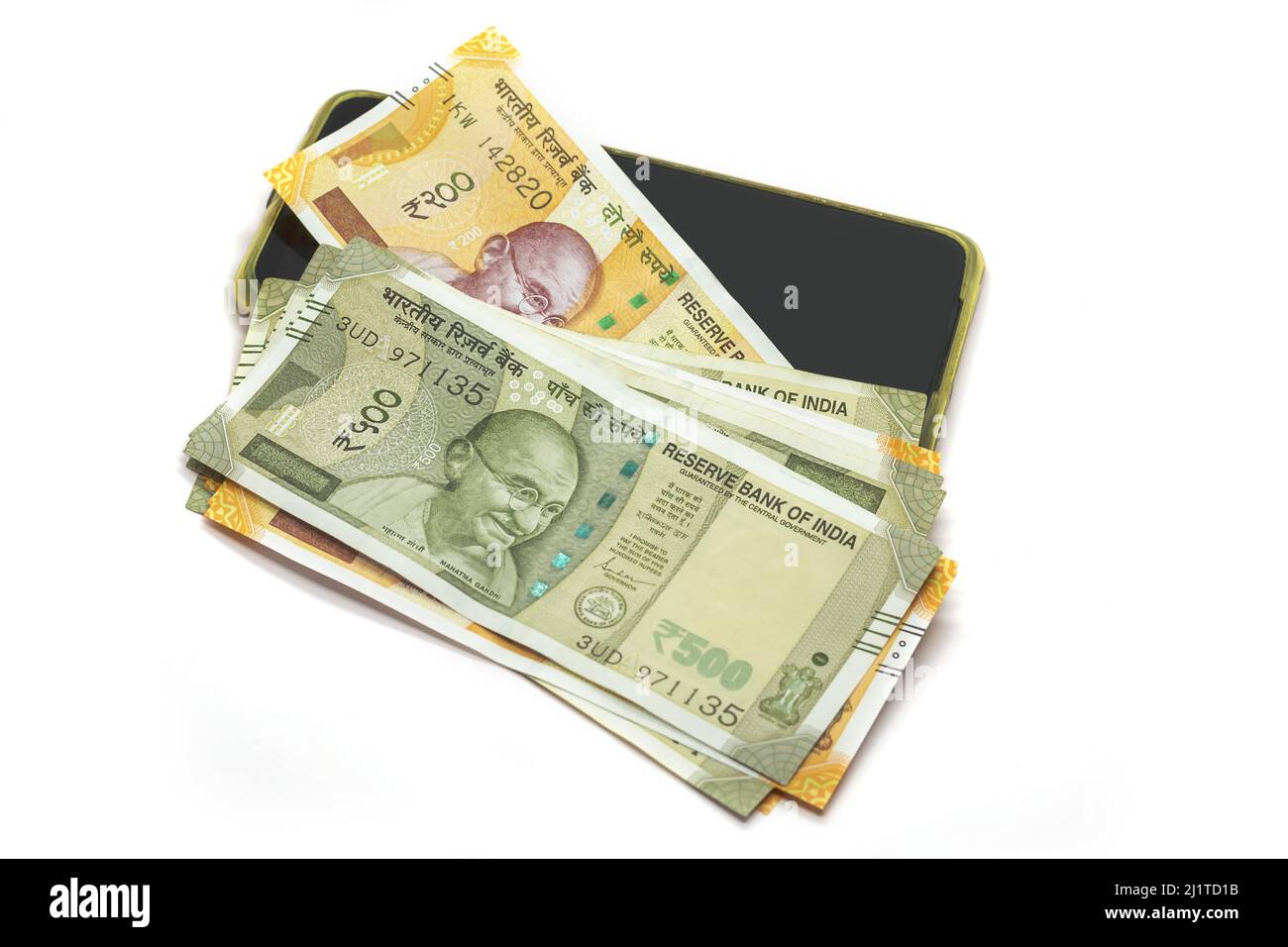 A closeup shot of 200 and 500 Indian rupees and a mobile phone isolated ...