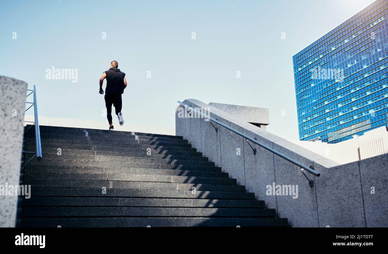 Every step is one step closer to your goal. Rearview shot of a young ...