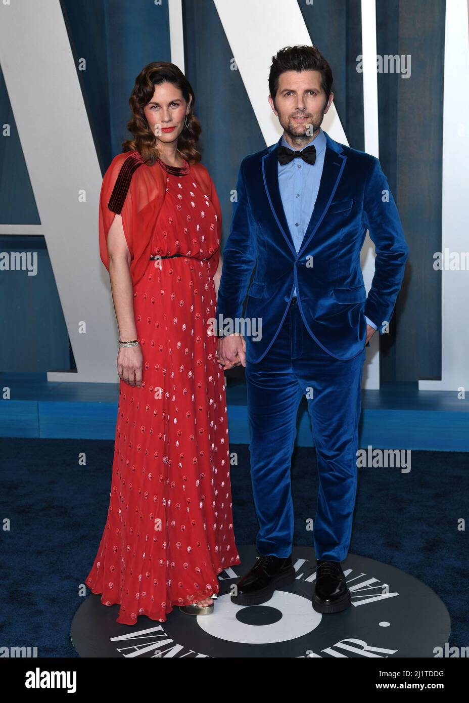 Naomi Scott and Adam Scott walking on the red carpet at the 2022 Vanity Fair Oscar Party held at ...