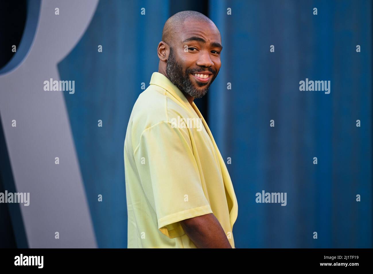 Donald Glover walking on the red carpet at the 2022 Vanity Fair Oscar ...