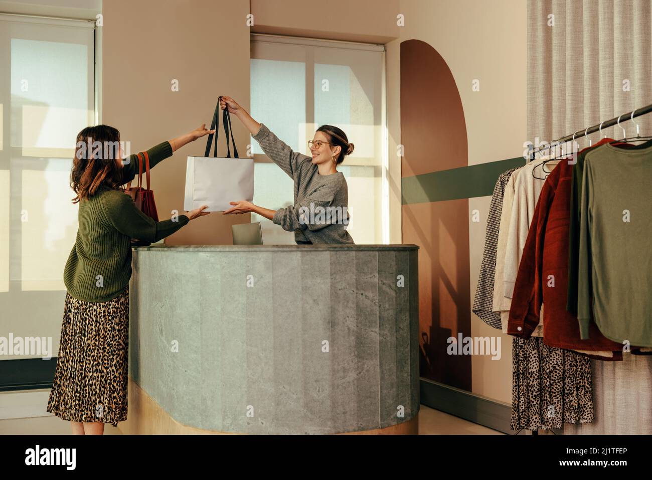 Handing a bag hi-res stock photography and images - Alamy