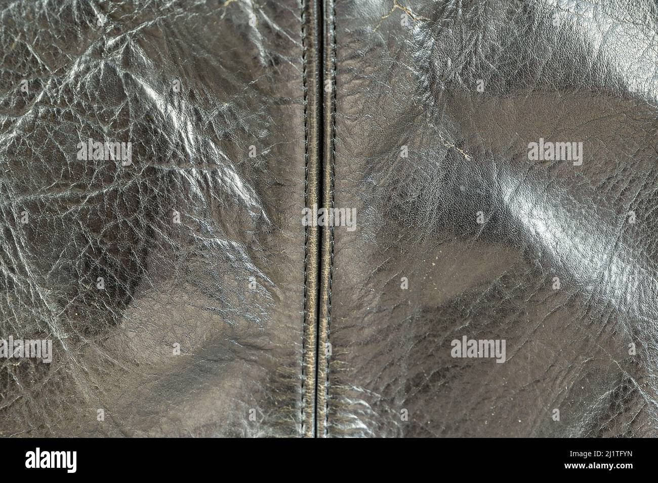 Black leather texture. Glossy leather surface with a vertical line ...
